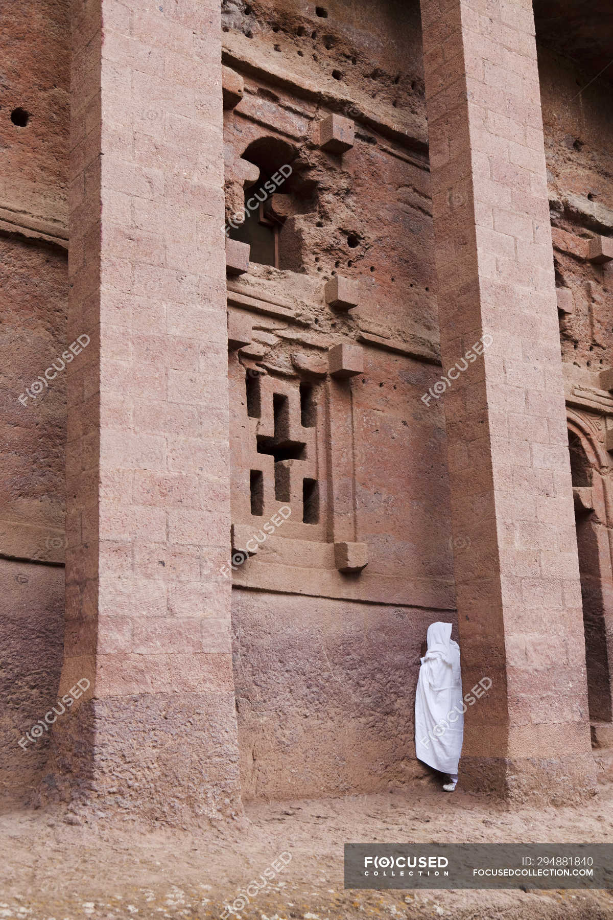 The rock-hewn churches of Lalibela in Ethiopia. Pilgrim praying in ...