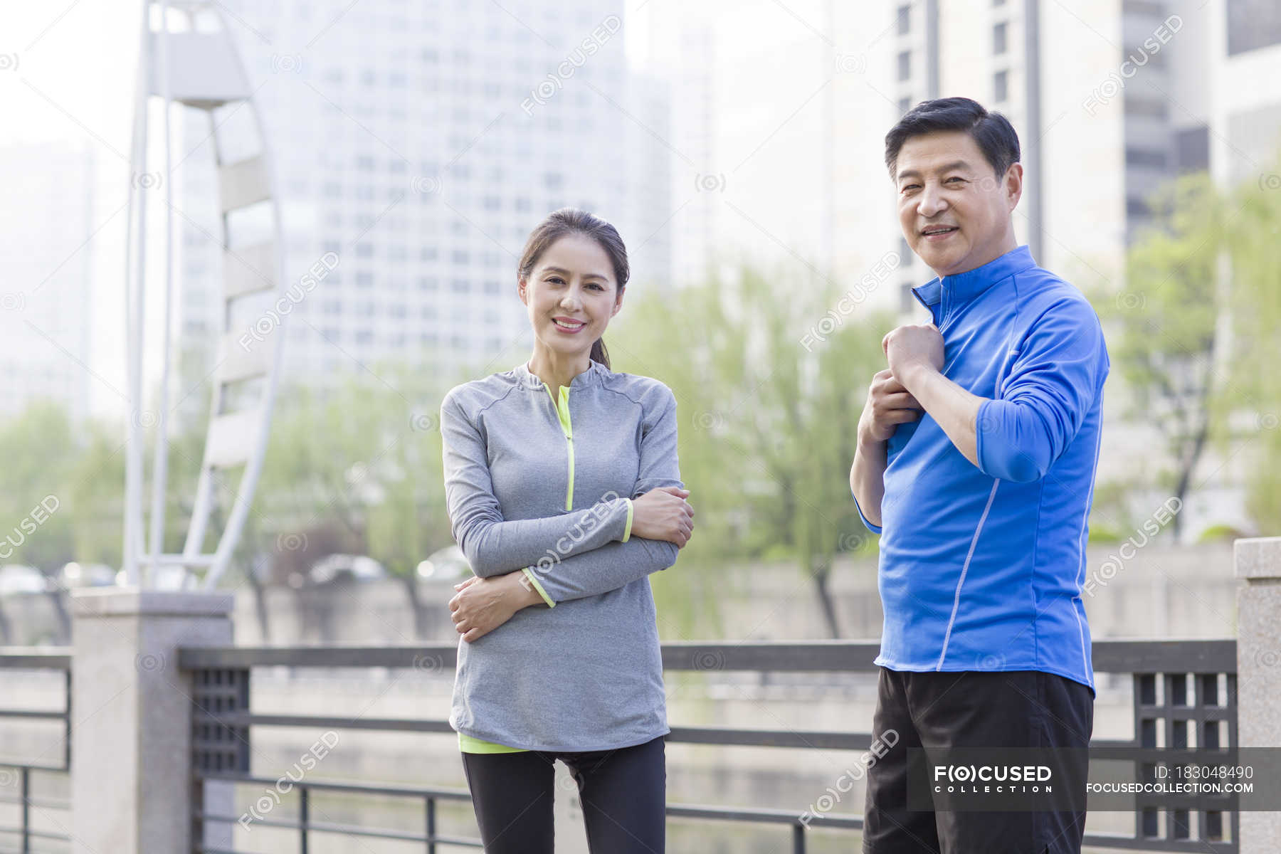 Mature chinese couple resting after exercising — selective focus, leisure - Stock Photo | #183048490