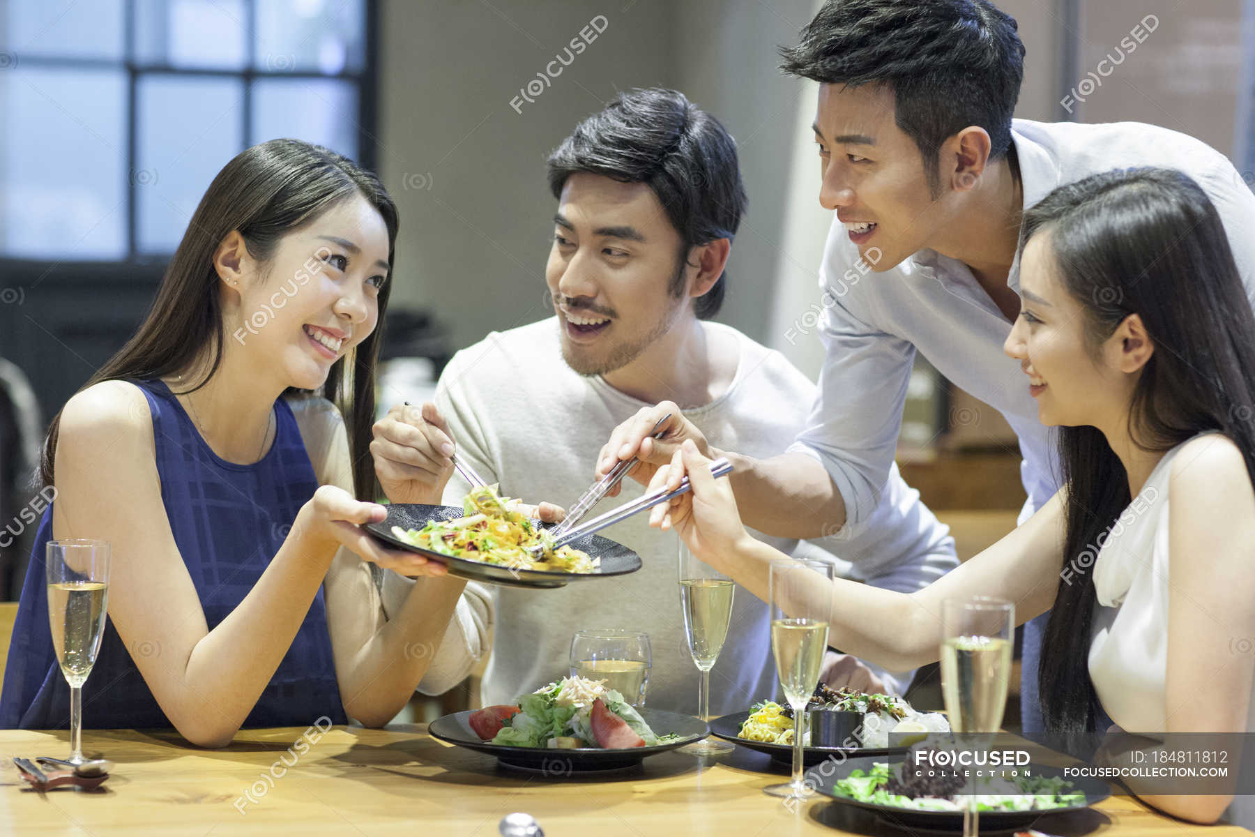 Chinese Friends Sharing Meal In Restaurant — Women Champagne Stock