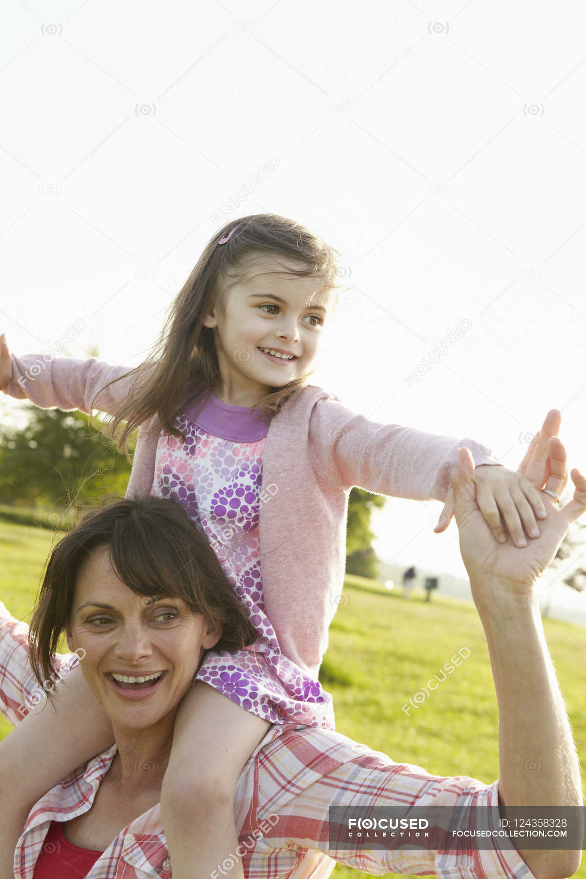 Mother carrying her daughter — piggyback, candid - Stock Photo | #124358328 Mother carrying her daughter — piggyback, candid - Stock Photo | #124358328