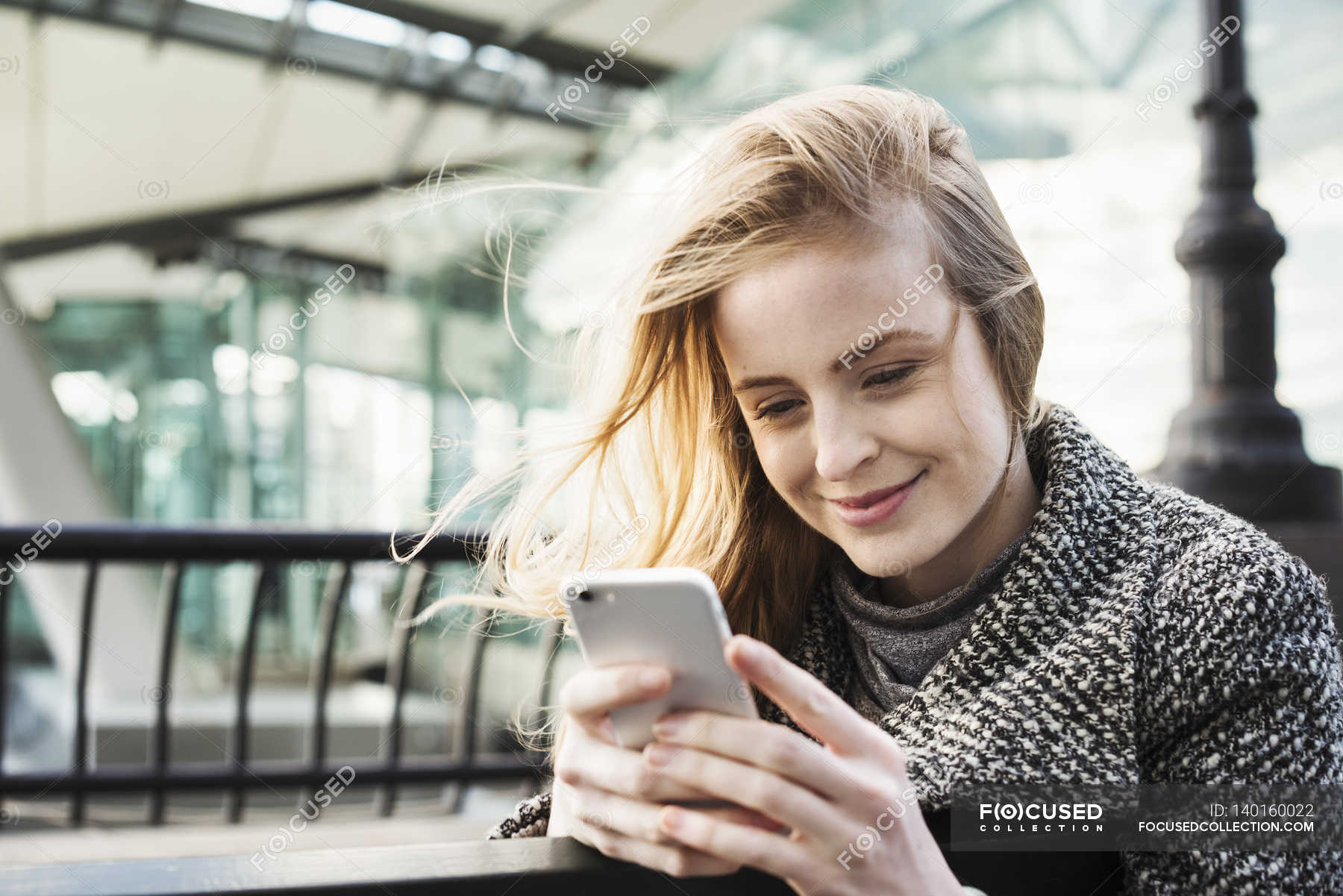 Woman checking smartphone — blond hair, device - Stock Photo | #140160022