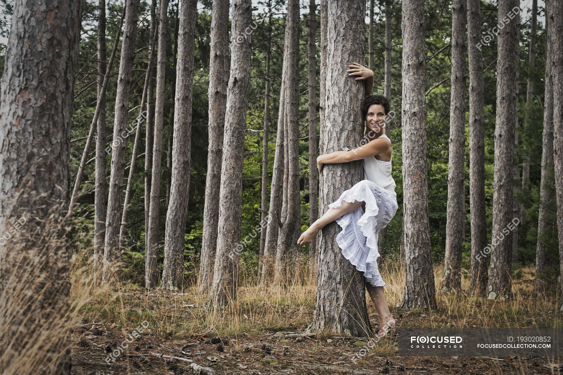 Woman Hugging Tree While Dance And Looking In Camera In Forest — Tree