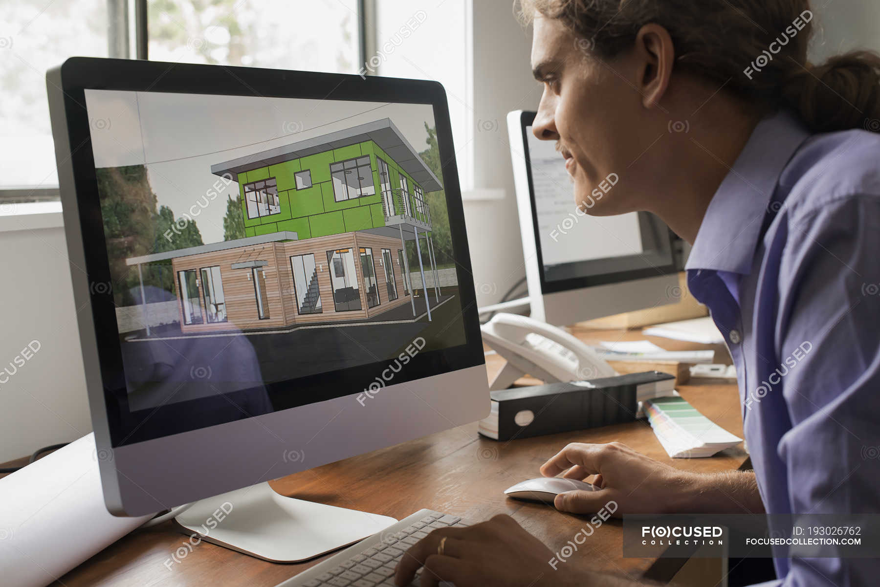 Architect working on green construction project at computer monitor in ...
