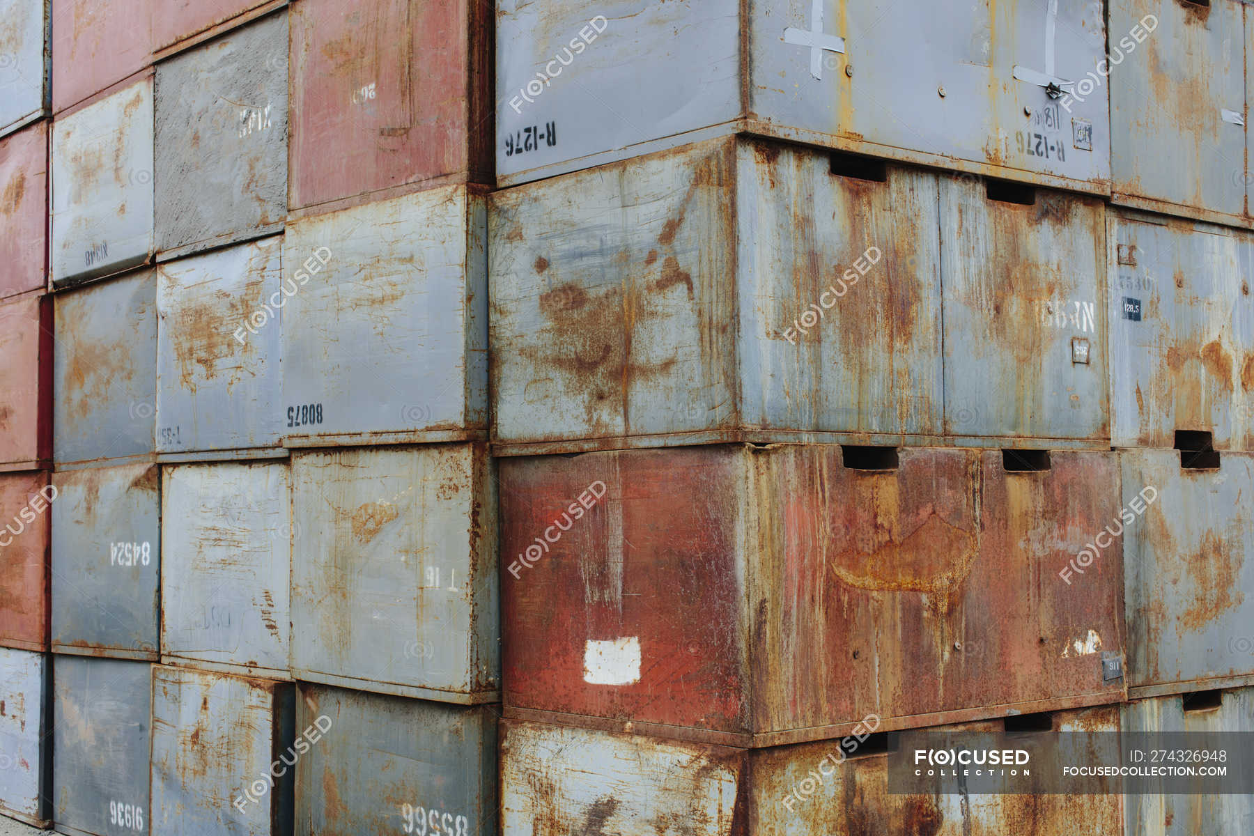 Stacks of rusty metal containers with numbers at loading dock ... Stacks of rusty metal containers with numbers at loading dock ...