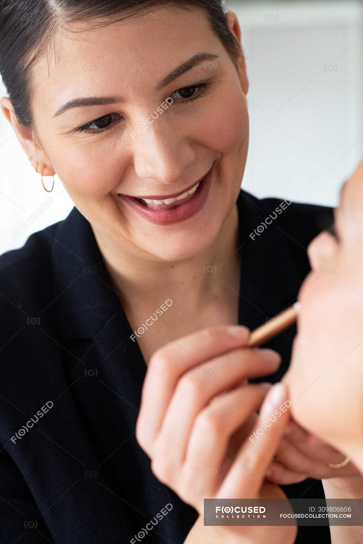 Professional make-up artist applying cosmetics at work, creating look ...
