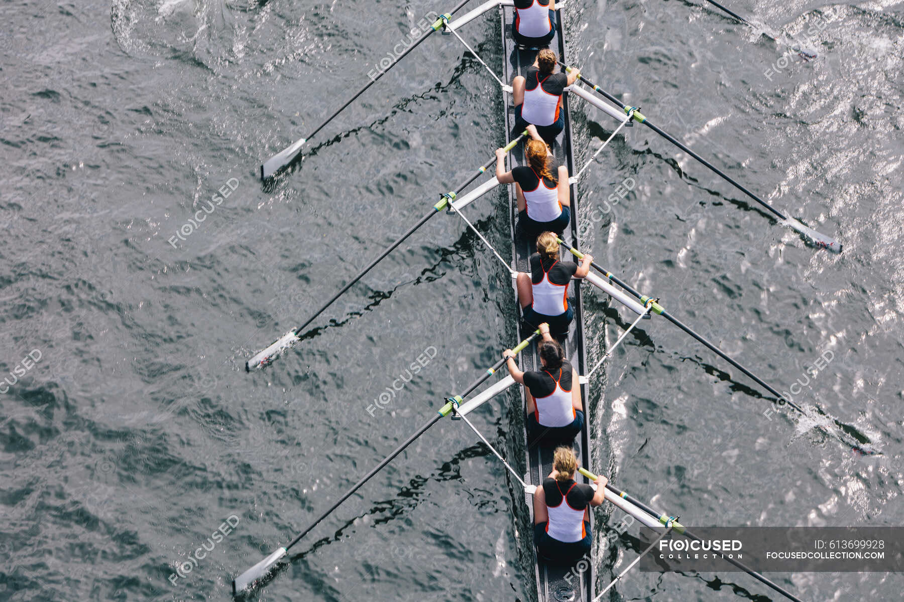 Overhead view of female crew racers rowing in an octuple racing shell, an eights team ...