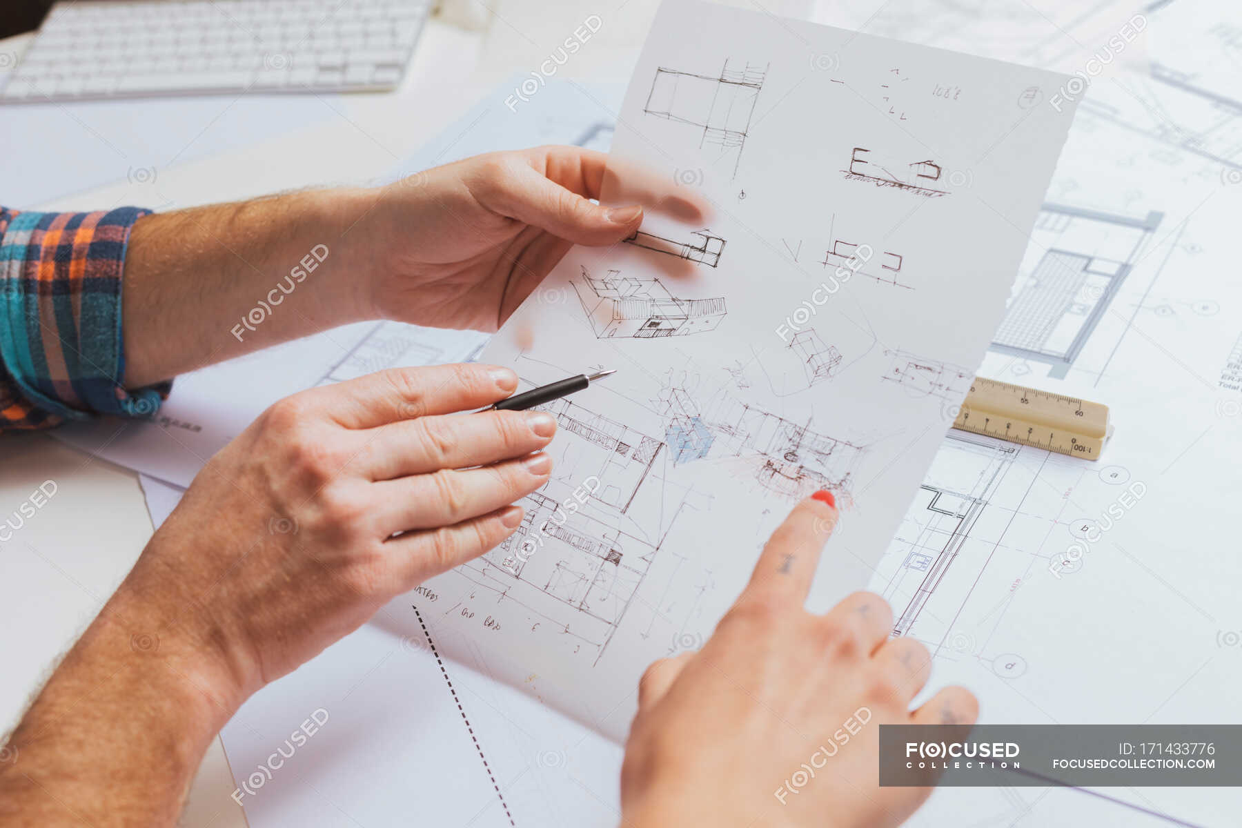 Male hands showing blueprints during female hand pointing — plan, work ...
