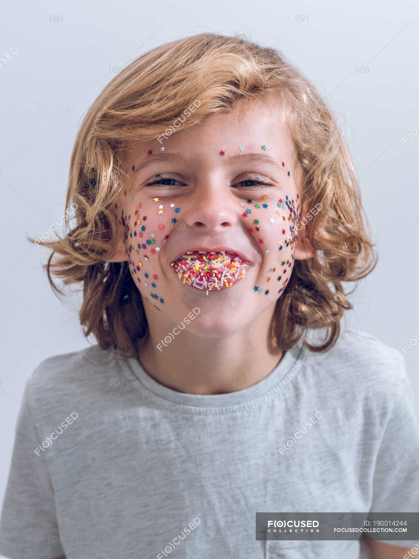 Cheerful boy with confetti on face — charming, glitters - Stock Photo ... Cheerful boy with confetti on face — charming, glitters - Stock Photo ...