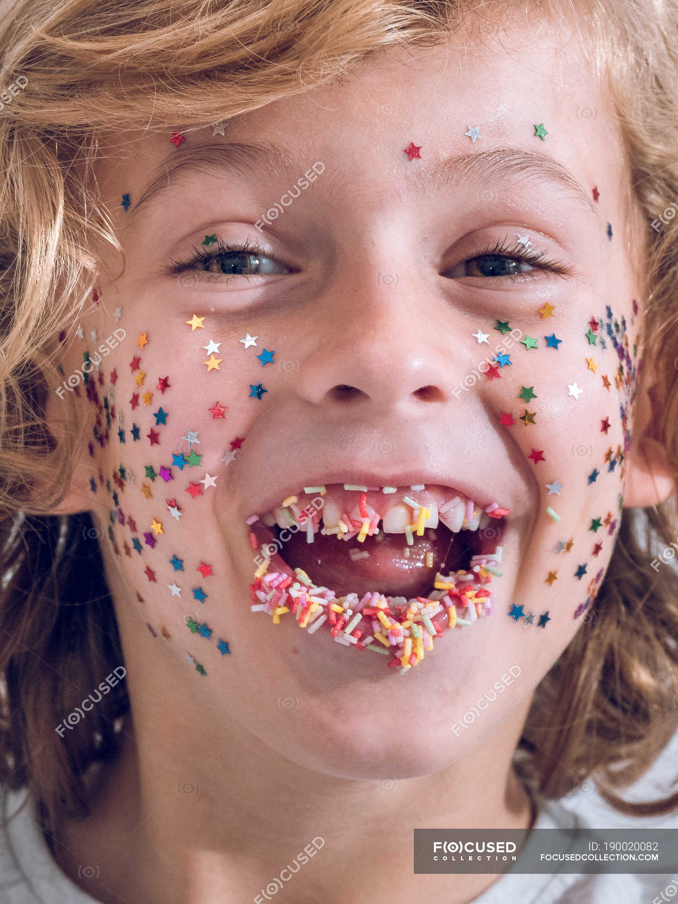 Portrait of cheerful boy with confetti on face — young, close up ... Portrait of cheerful boy with confetti on face — young, close up ...