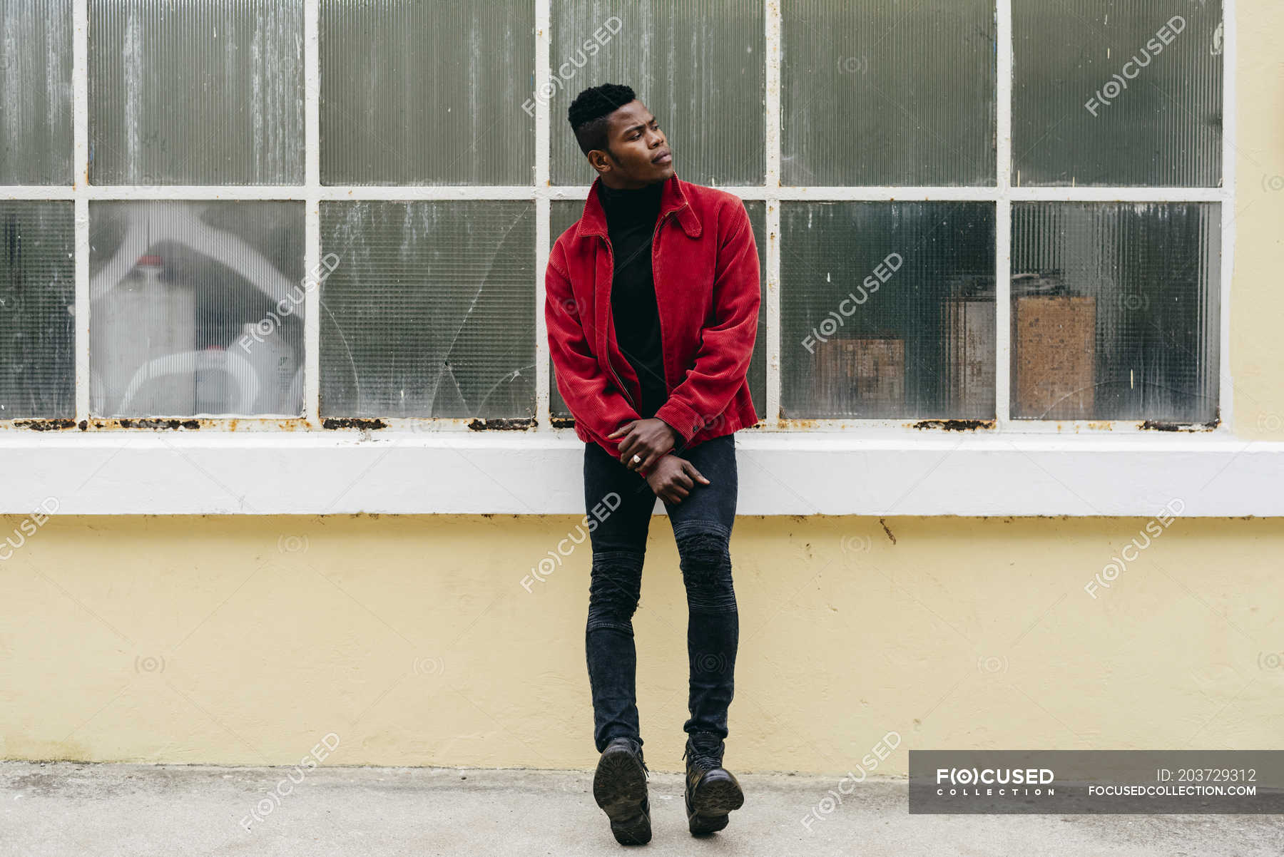Black man leaning on glass wall — standing, serious - Stock Photo ...