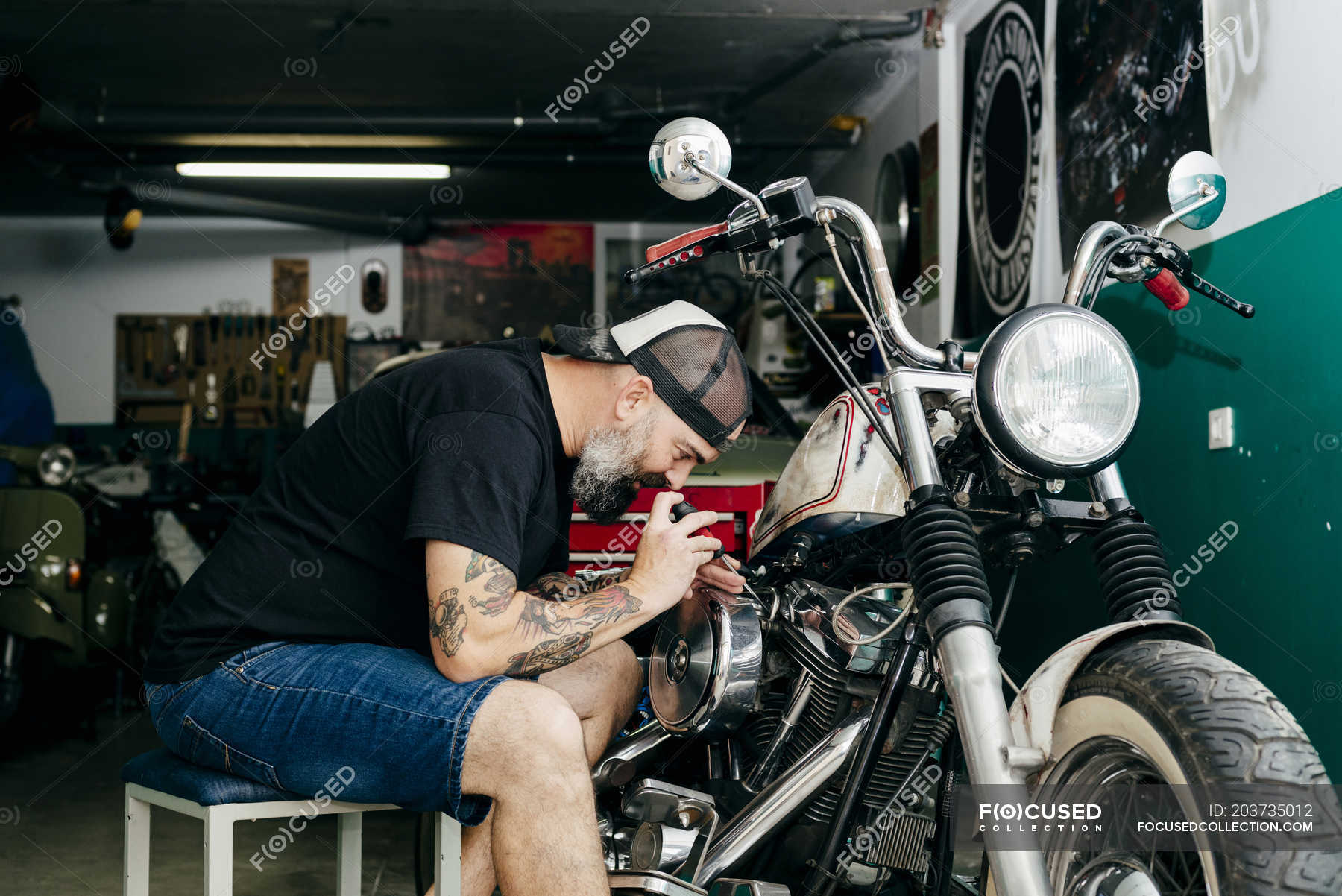 Mechanic repairing motorcycle — mechanical, bike - Stock Photo | #203735012