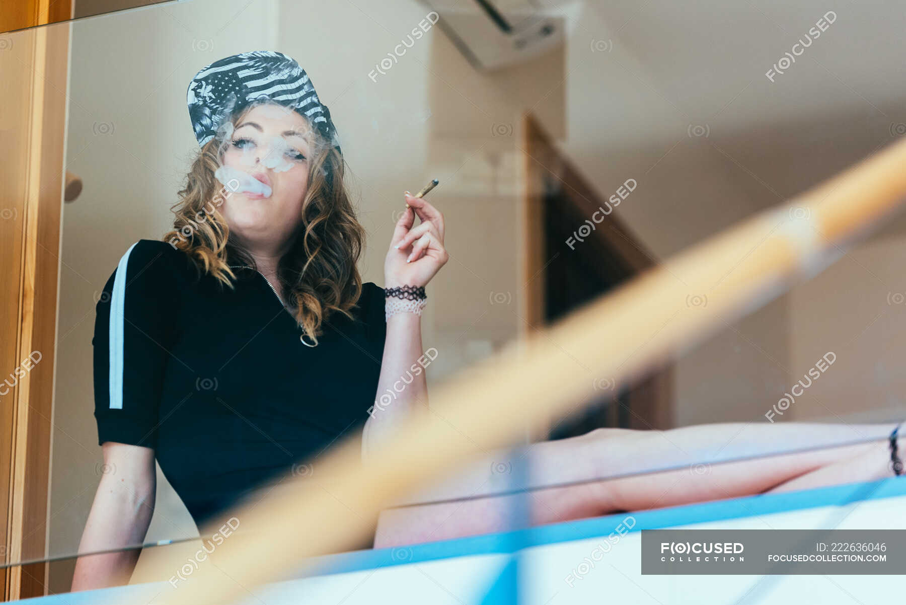 Young woman smoking a cannabis joint — Igniting, weed - Stock Photo | #222636046