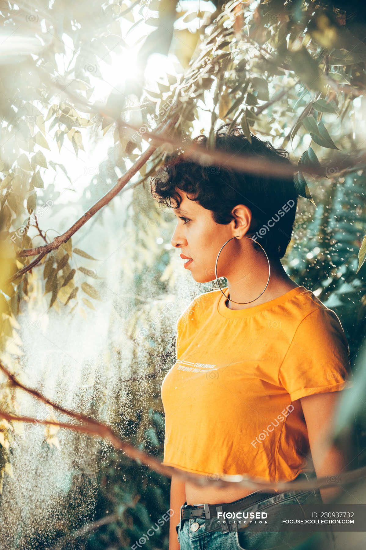 Thoughtful Sensual Brunette With Short Hair Standing In Mist In Green Vegetation With Sunlight 