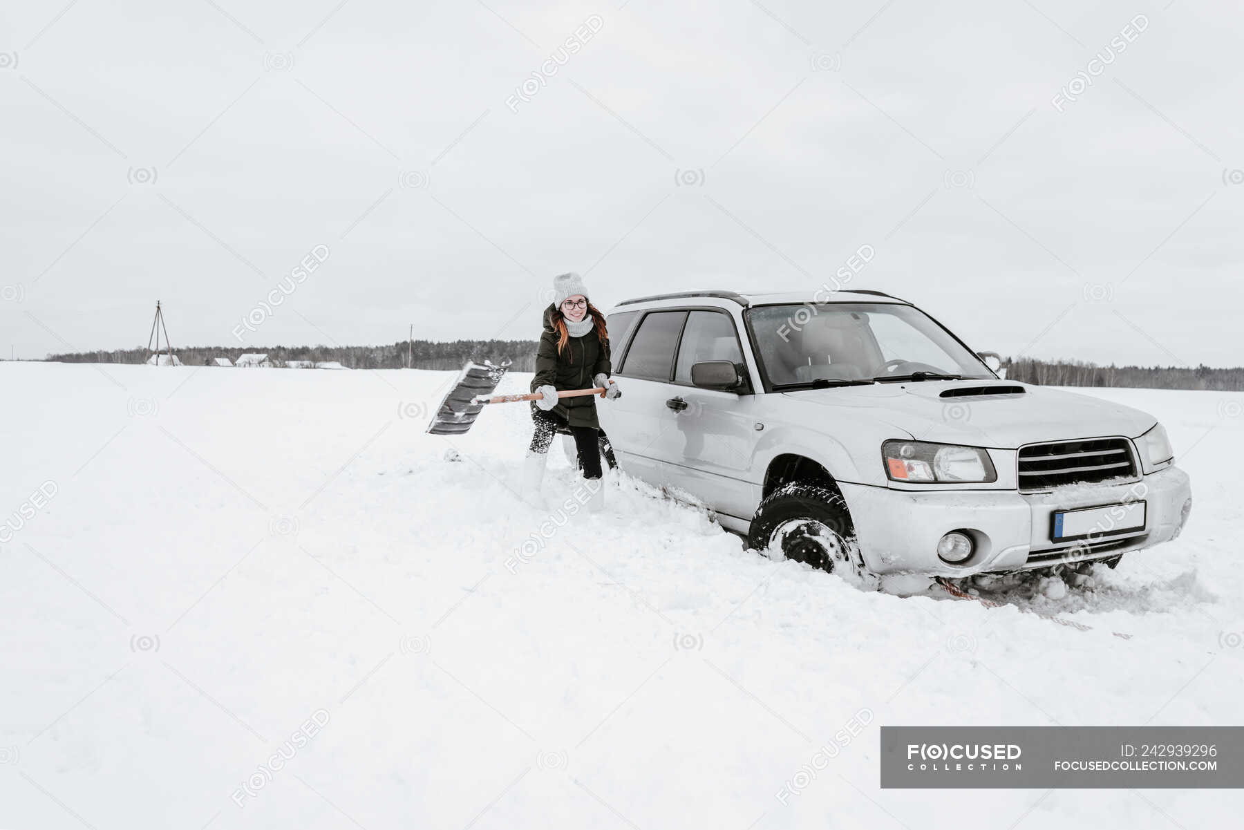 Woman with shovel near car on snow field — meadow, lady - Stock Photo ...
