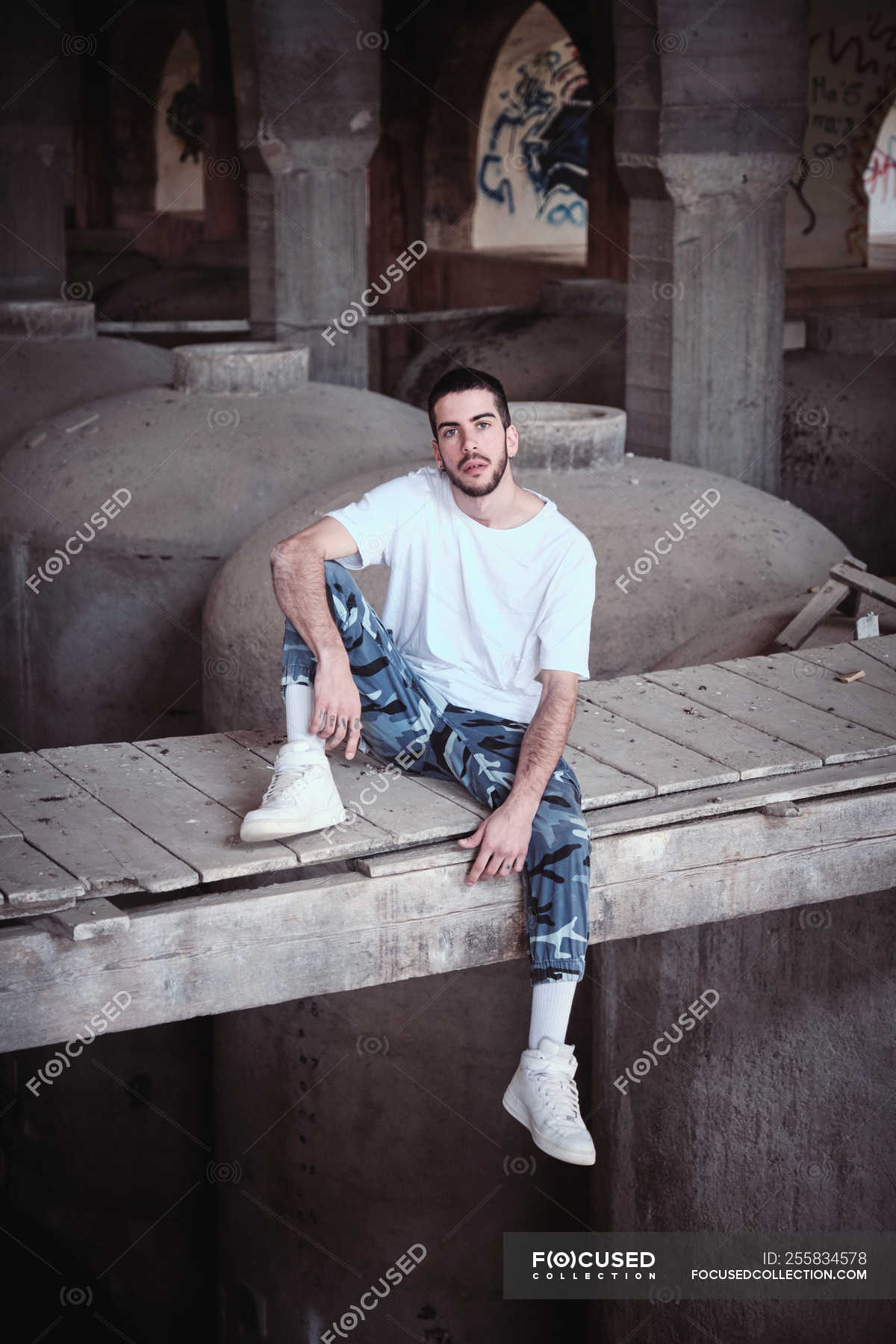 Man sitting on bridge inside old building — handsome, relaxing - Stock ...