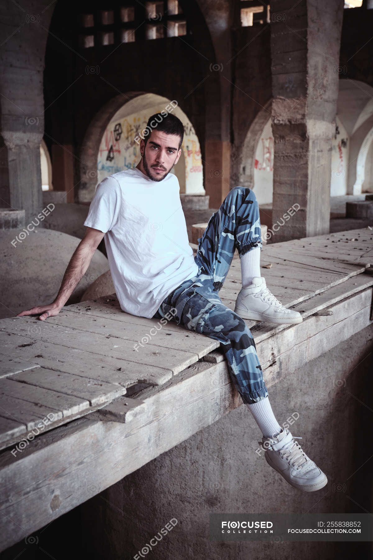 Man sitting on bridge inside old building — attractive, serious - Stock ...