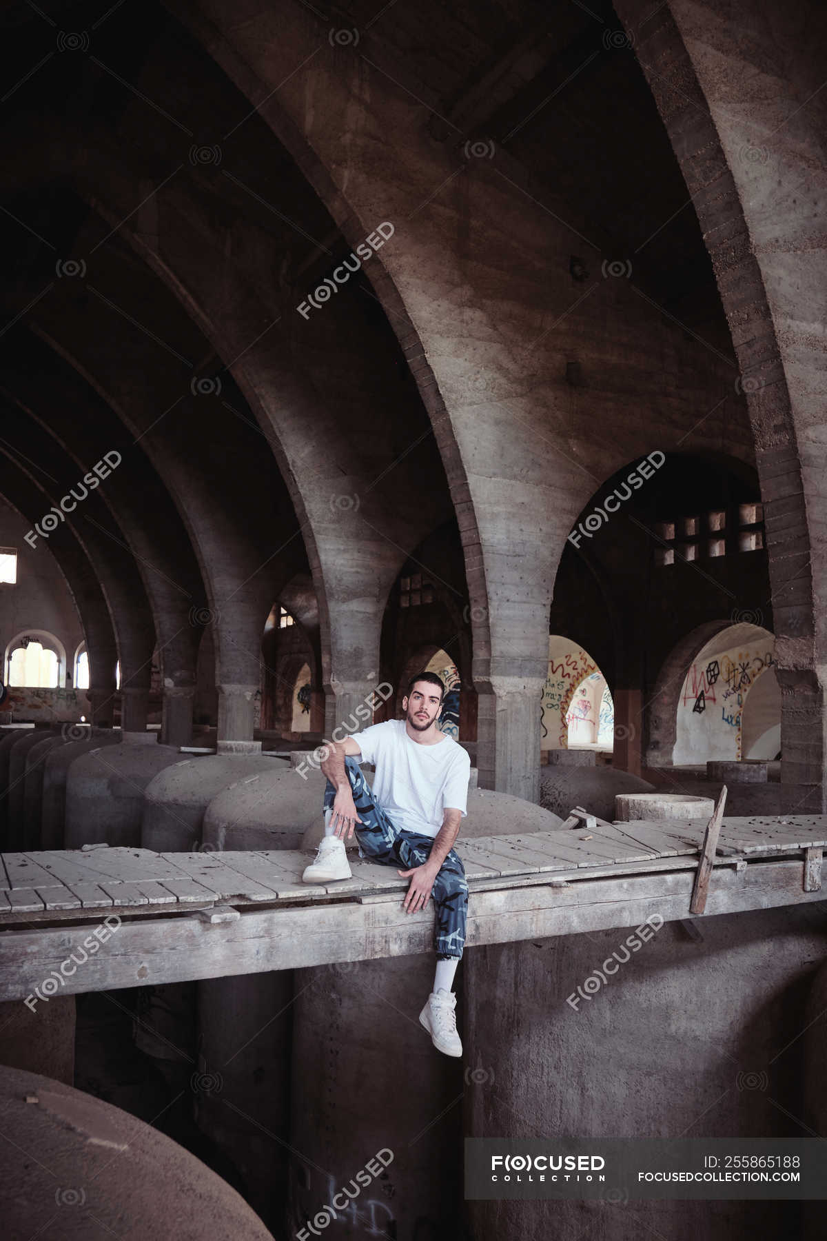 Man sitting on bridge inside old building — model, masculine - Stock ...