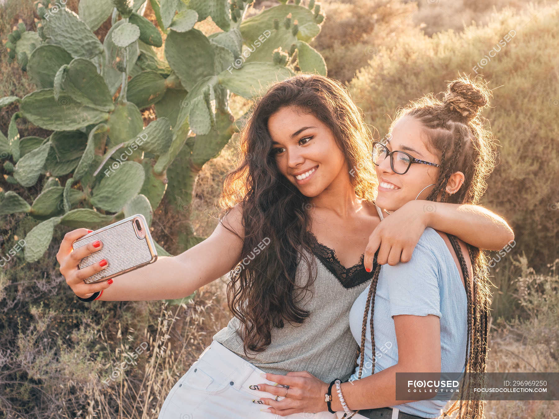 Smiling trendy young women taking selfie at countryside — device ... Smiling trendy young women taking selfie at countryside — device ...