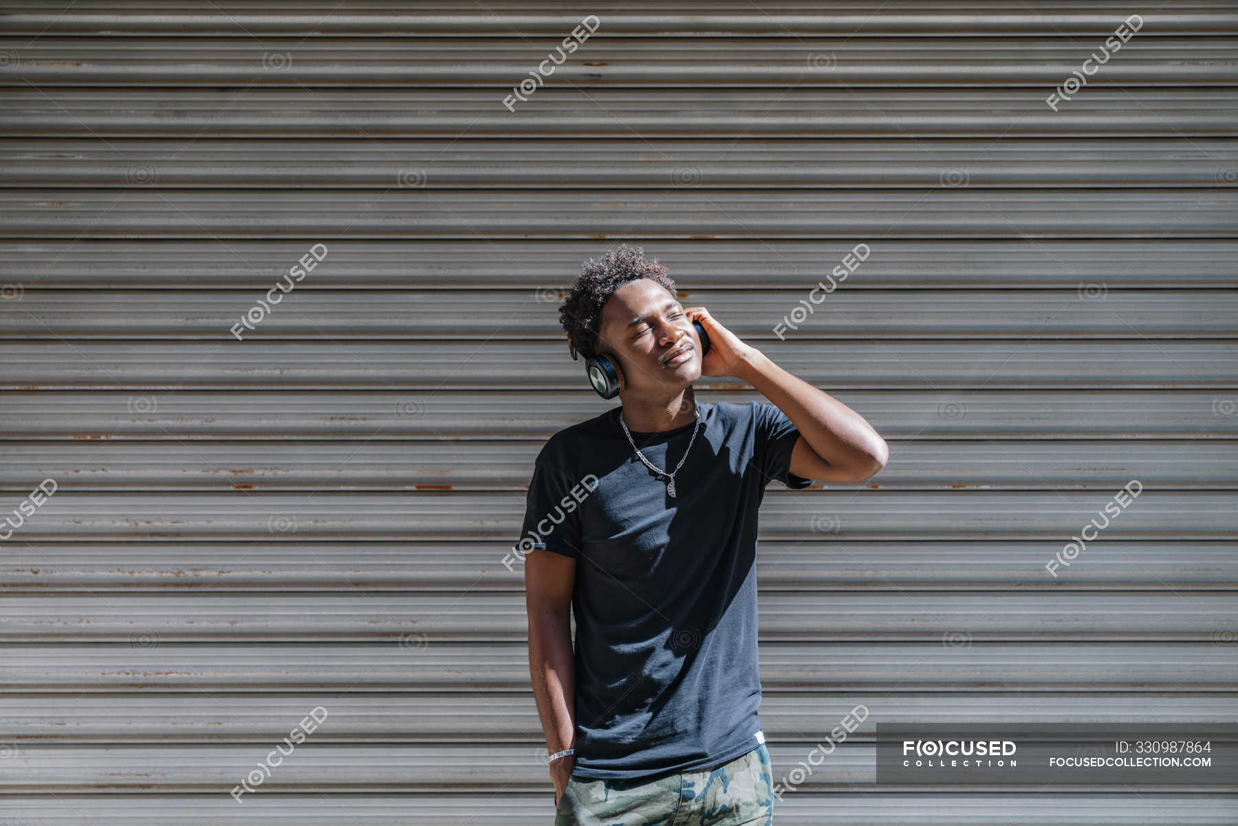 Stylish modern African American man with closed eyes and headphones ... Stylish modern African American man with closed eyes and headphones ...