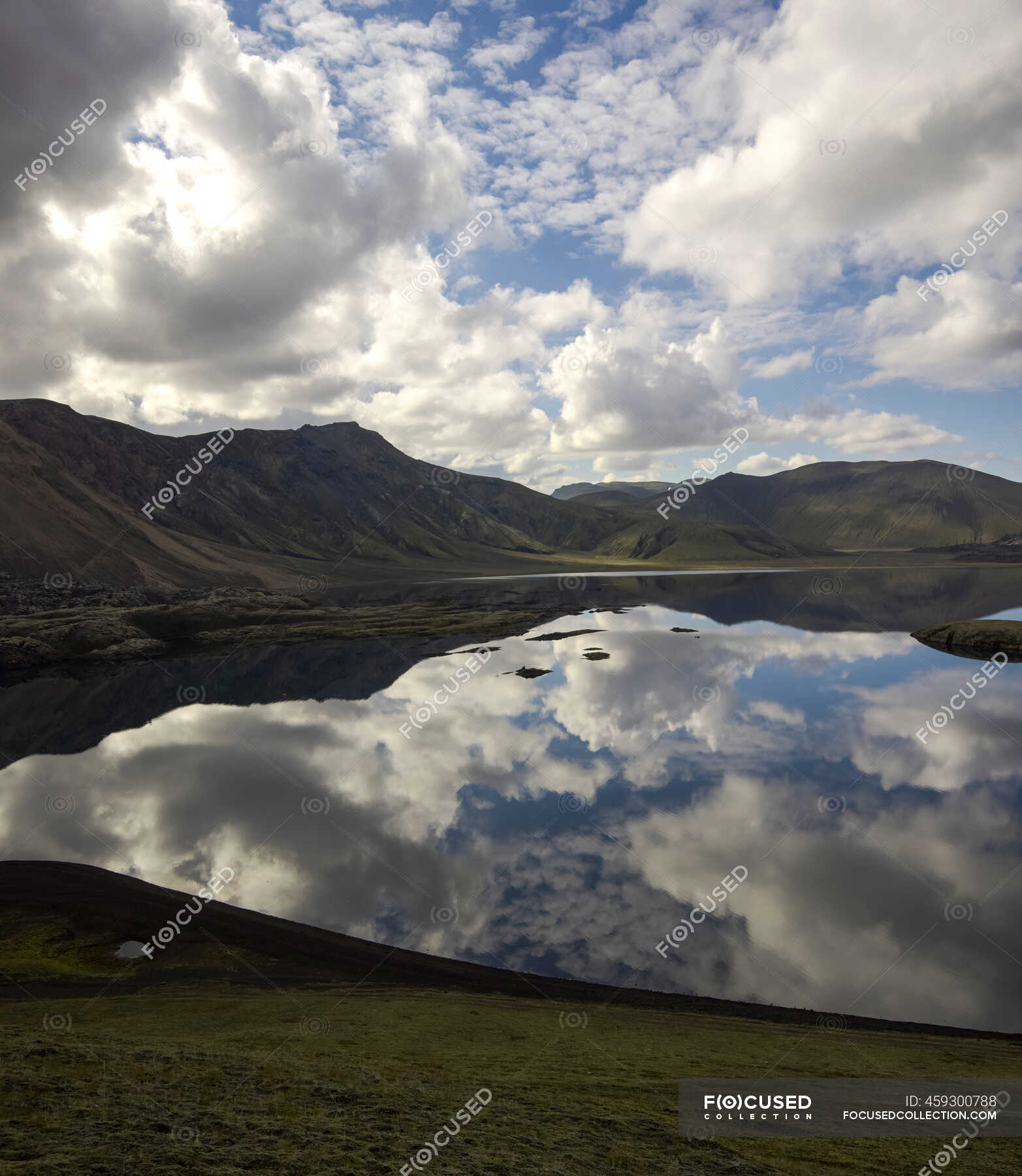 Breathtaking scenery of still tranquil lake reflecting clear blue sky ...