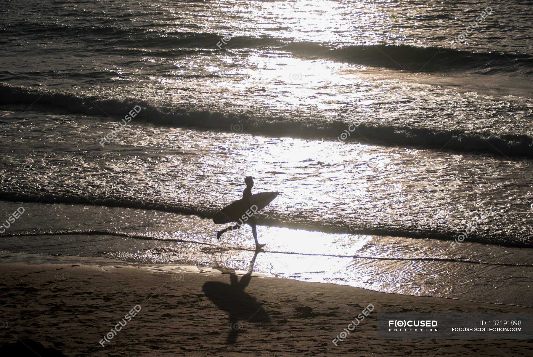 Surfer running on beach — horizontal, sunlight - Stock Photo | #137191898