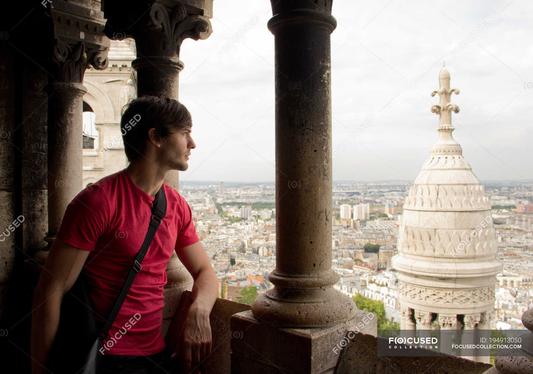 Man standing on balcony and looking at view of city — urban sprawl ...