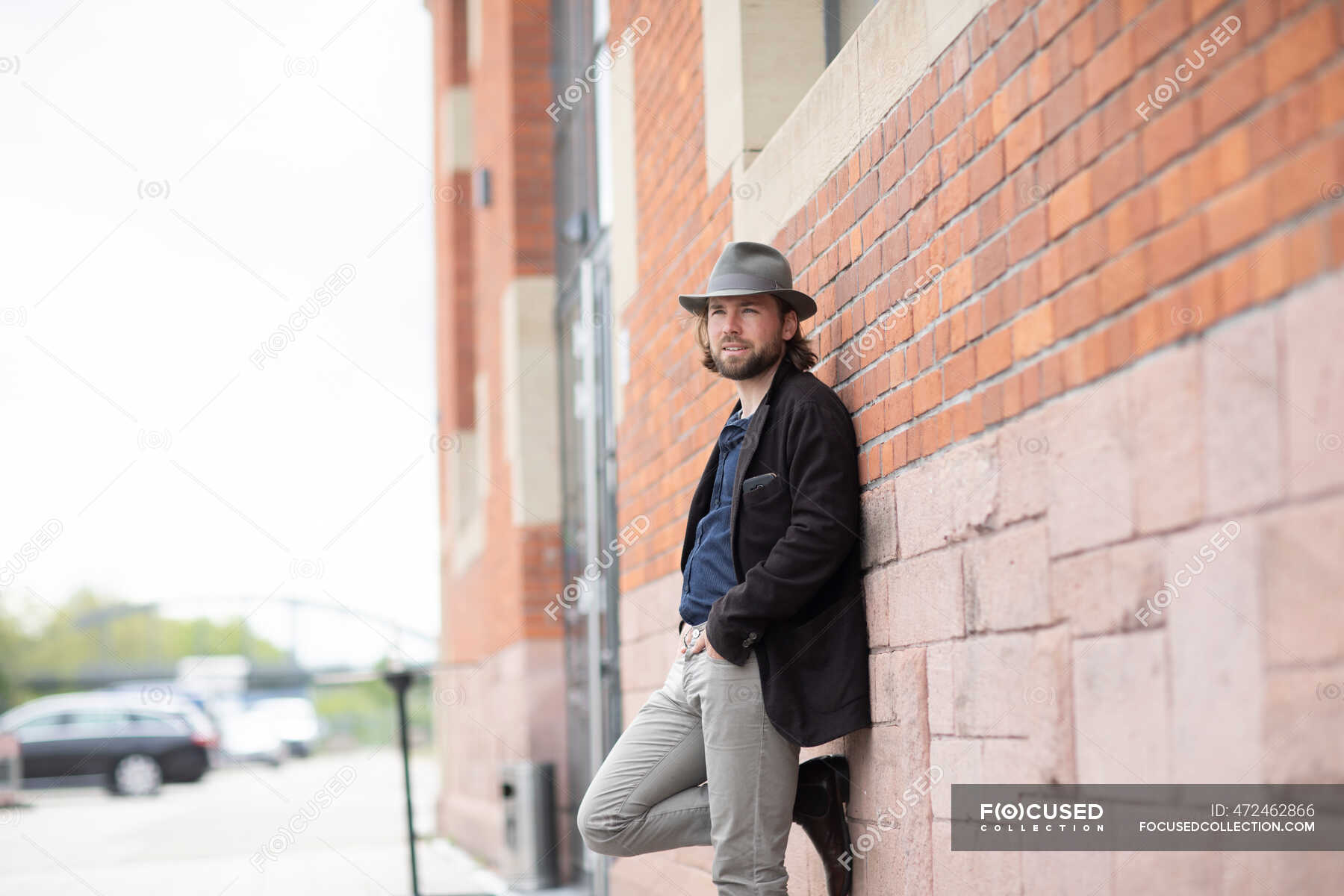 Portrait of a man leaning against a wall — Casual Clothing, beard ...