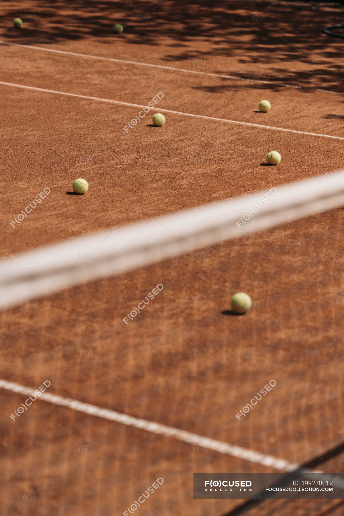 Tennis balls lying on court outdoors — net, sports - Stock Photo ...